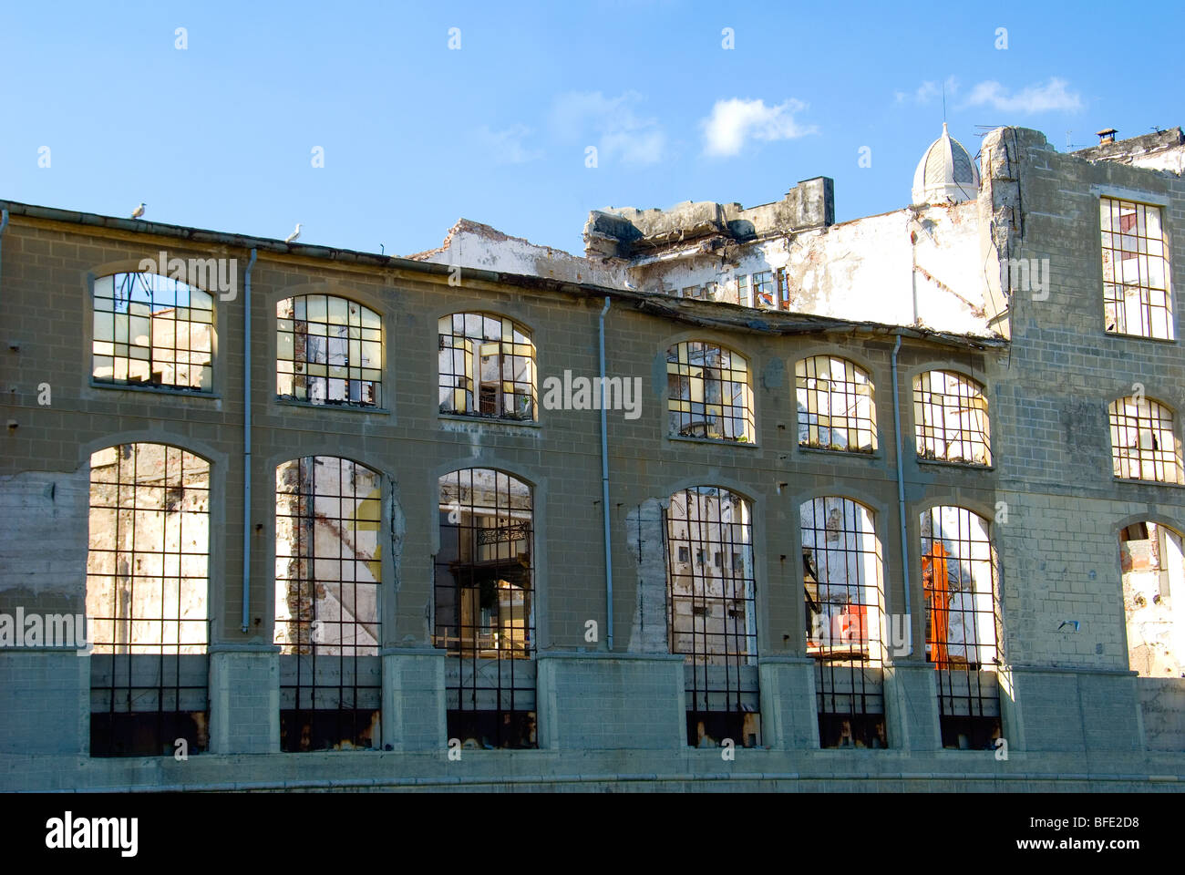 The remaining outer shell of a building being demolished for ...