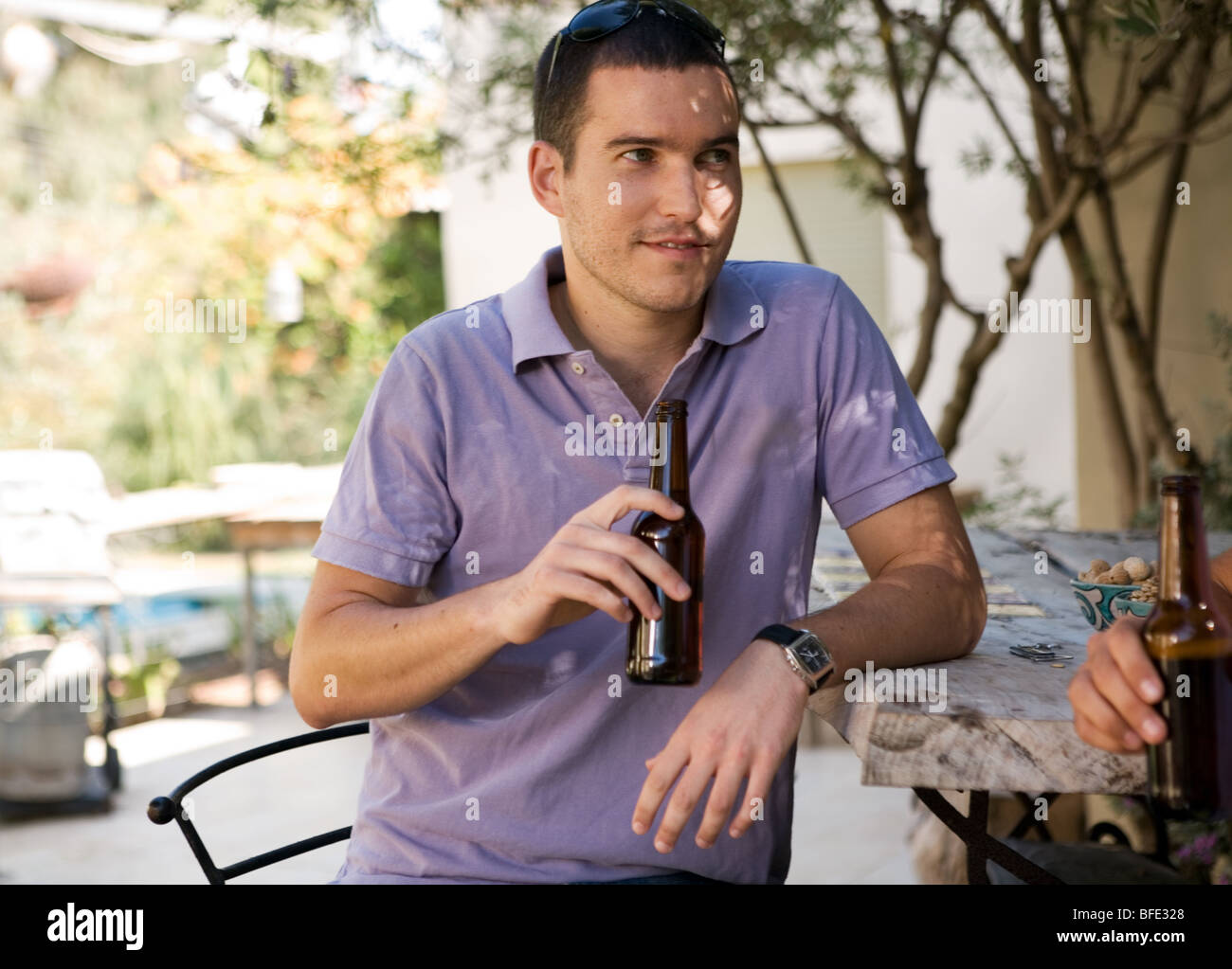 Man drinking beer in swimming hi-res stock photography and images - Alamy
