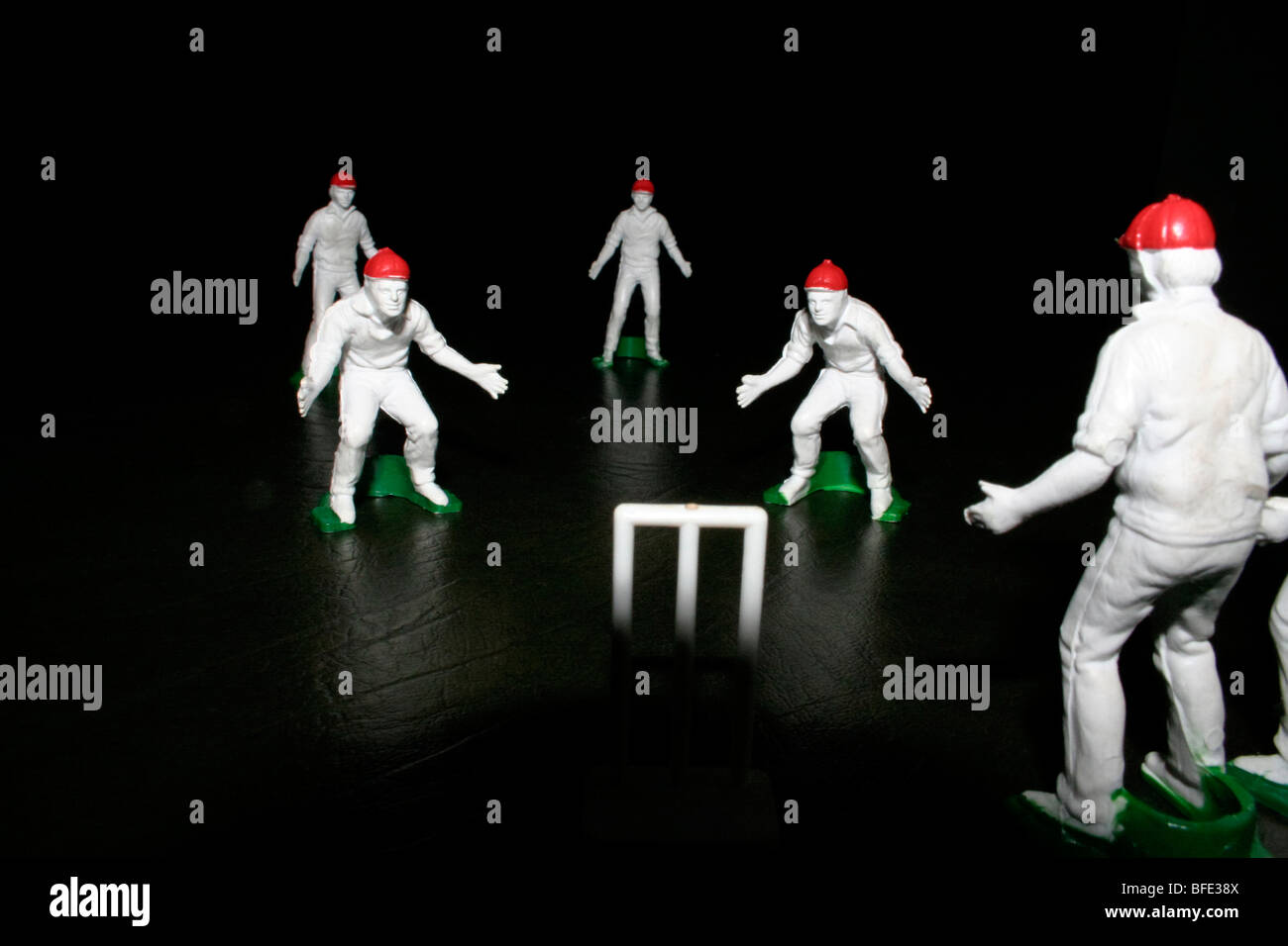 Toy men playing cricket on black background Stock Photo - Alamy