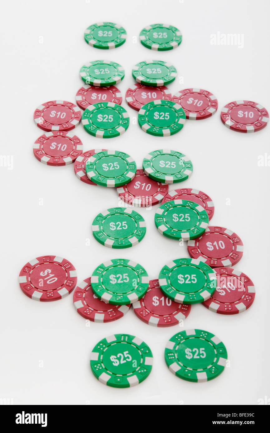 Gambling chips set out in the shape of the dollar symbol on white ...