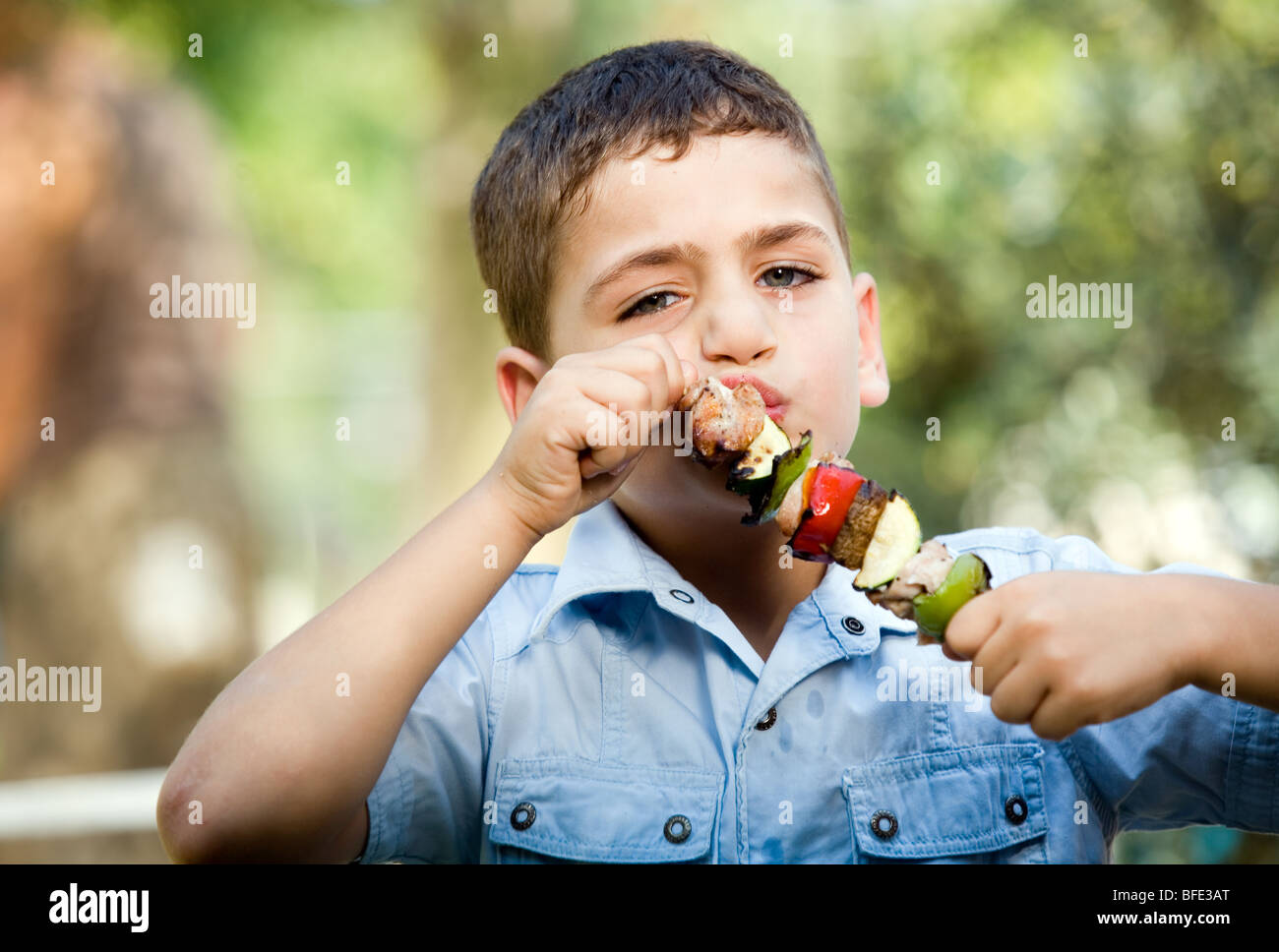 Boy eating a skewer hi-res stock photography and images - Alamy