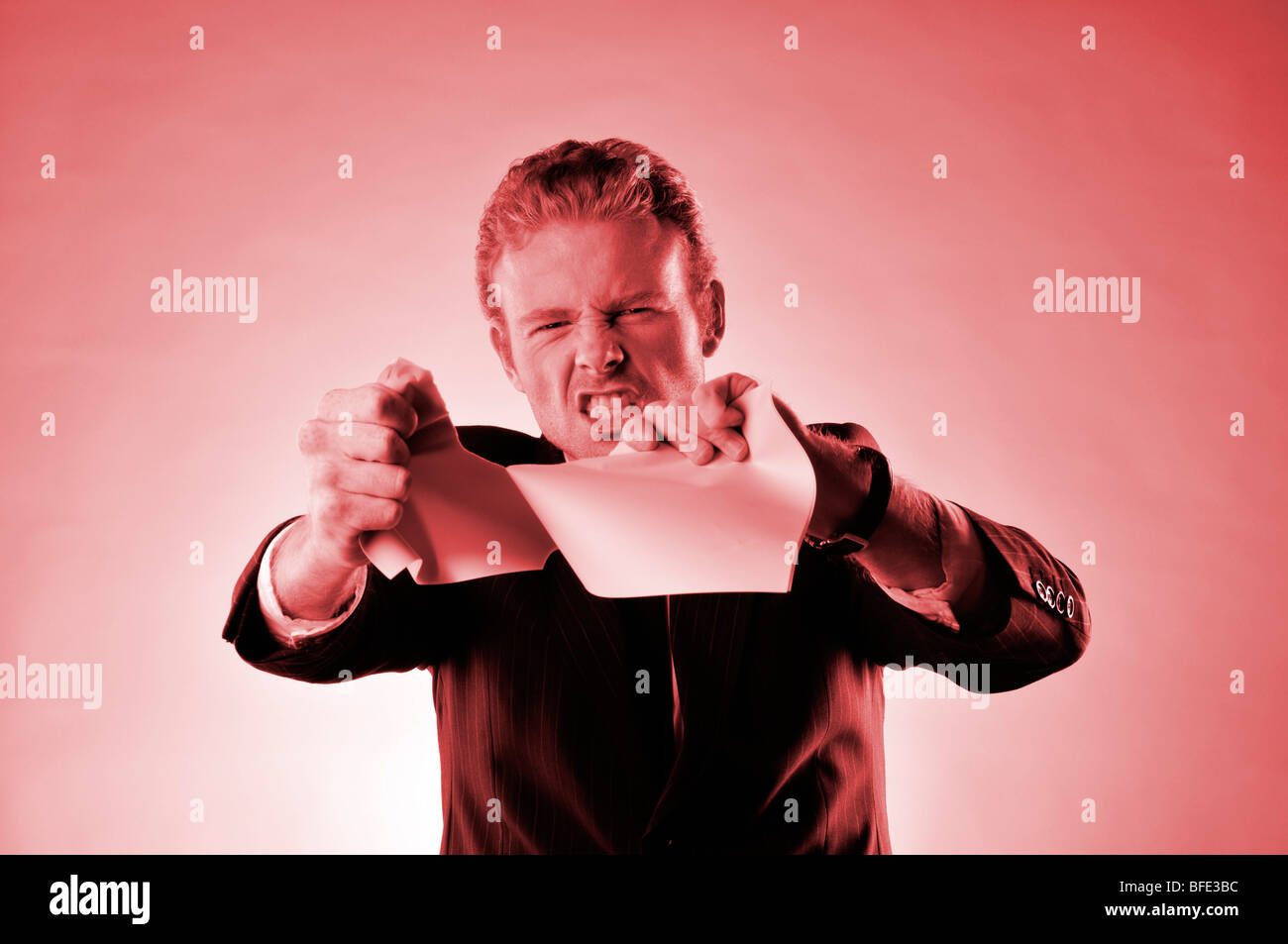 Angry man in suit tearing up papers Stock Photo - Alamy