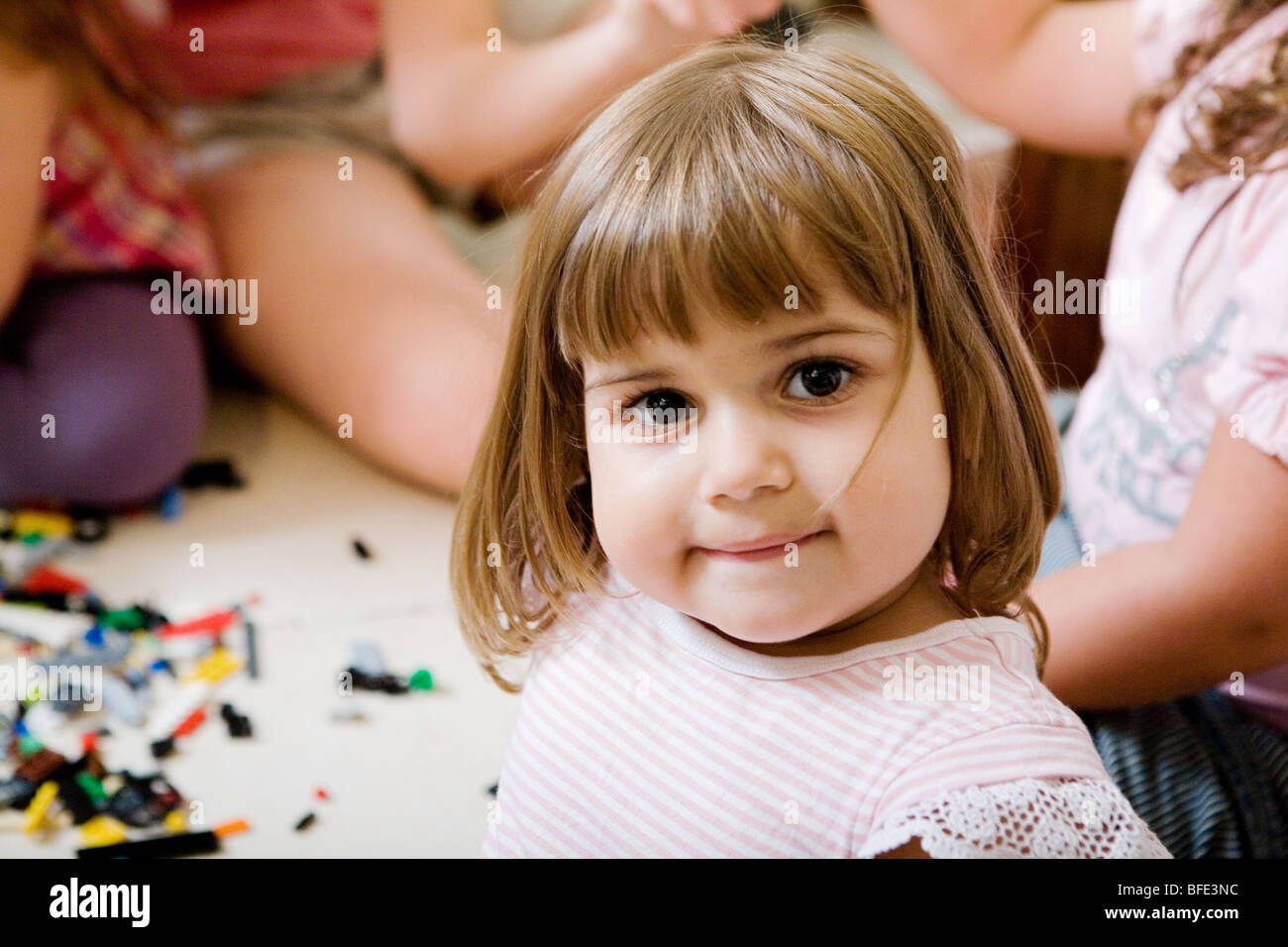 Cute girl looking at camera Stock Photo - Alamy