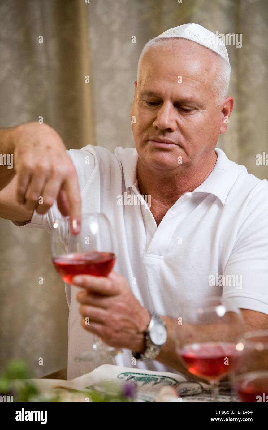 Dipping finger in wine (Passover tradition Stock Photo - Alamy