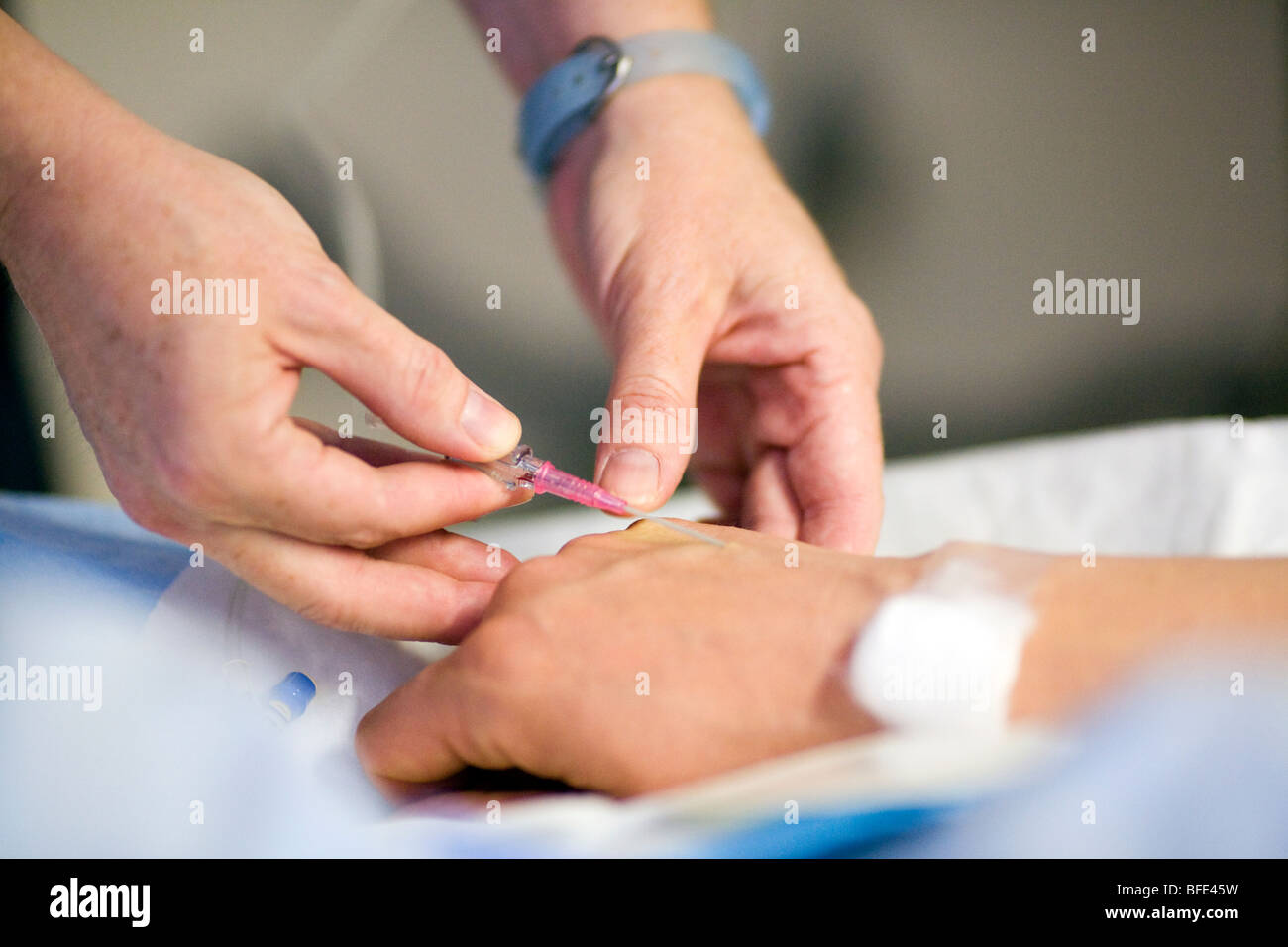 Close-up of hand of woman about to give birth receiving an intravenous ...