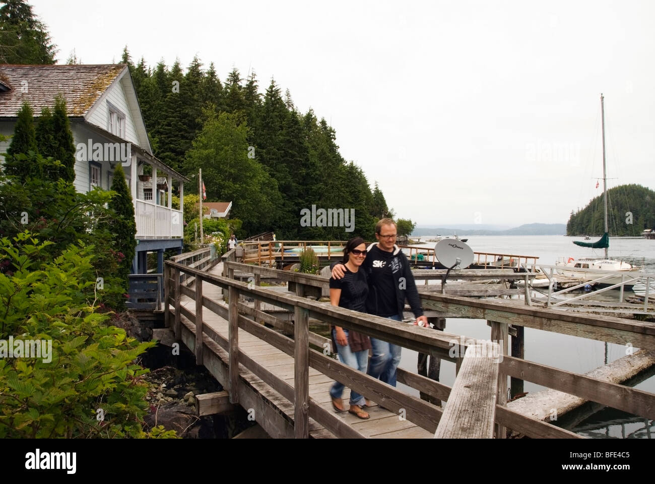 A couple on seaside boardwalk in the coastal village of Bamfield ...