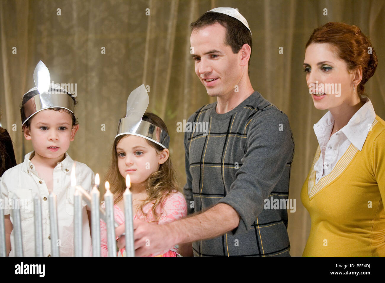 Hanukkah family lighting menorah hi-res stock photography and images ...