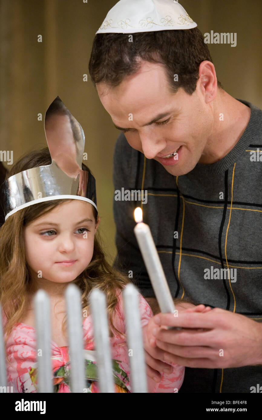 Father and daughter behind candles Stock Photo - Alamy
