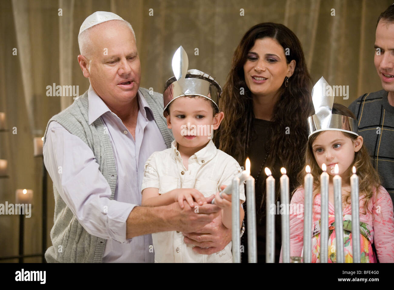 Family lighting Hanukkah candles Stock Photo - Alamy