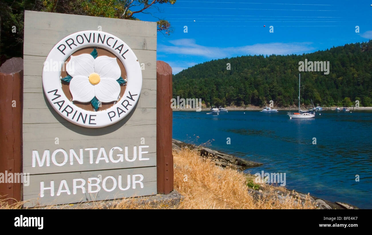 Boats lie at anchor in Montague Harbour Provincial Marine Park on ...