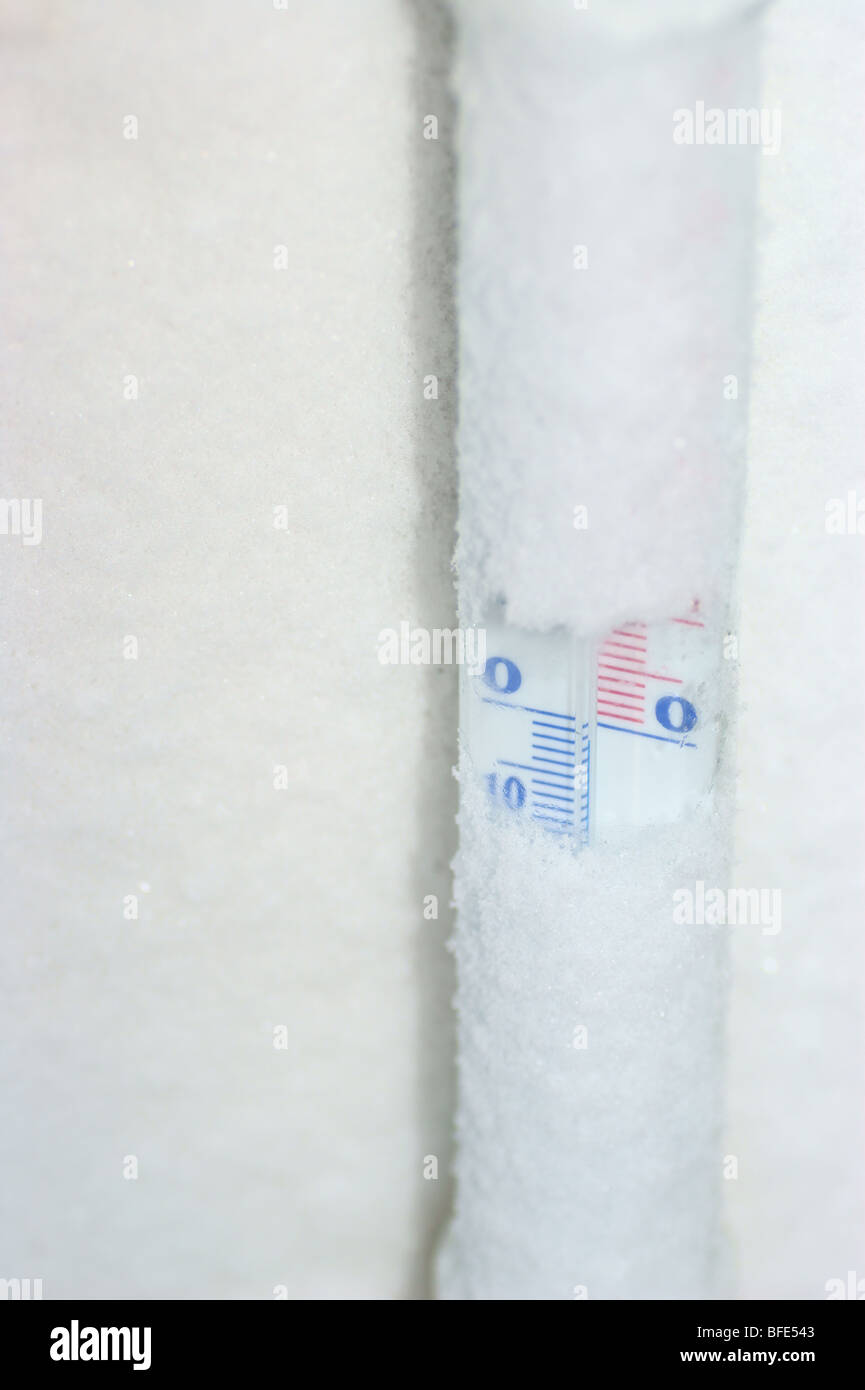 outdoor thermometer, winter and snow. Temperature is dropping below ...