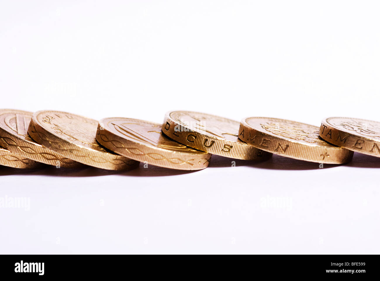 Money one pound coins on a white background with space for text or ...
