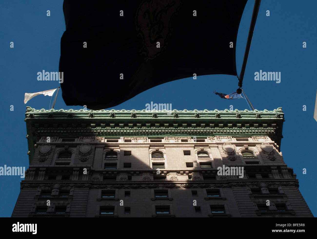 Flags fly high above the classical buildings of New York City and ...