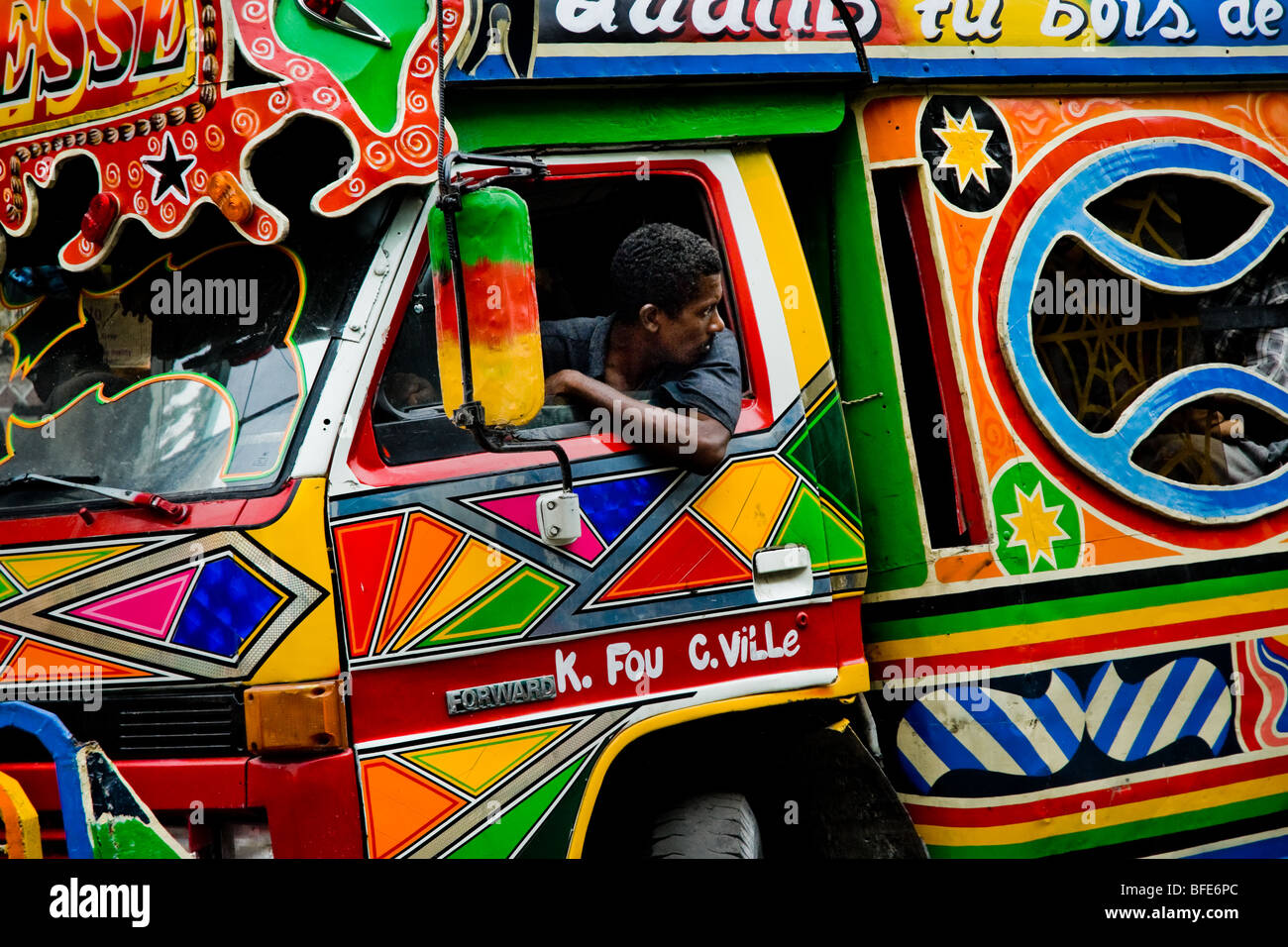 The tap-tap bus driver maneuvering his vehicle in heavy traffic of Port ...