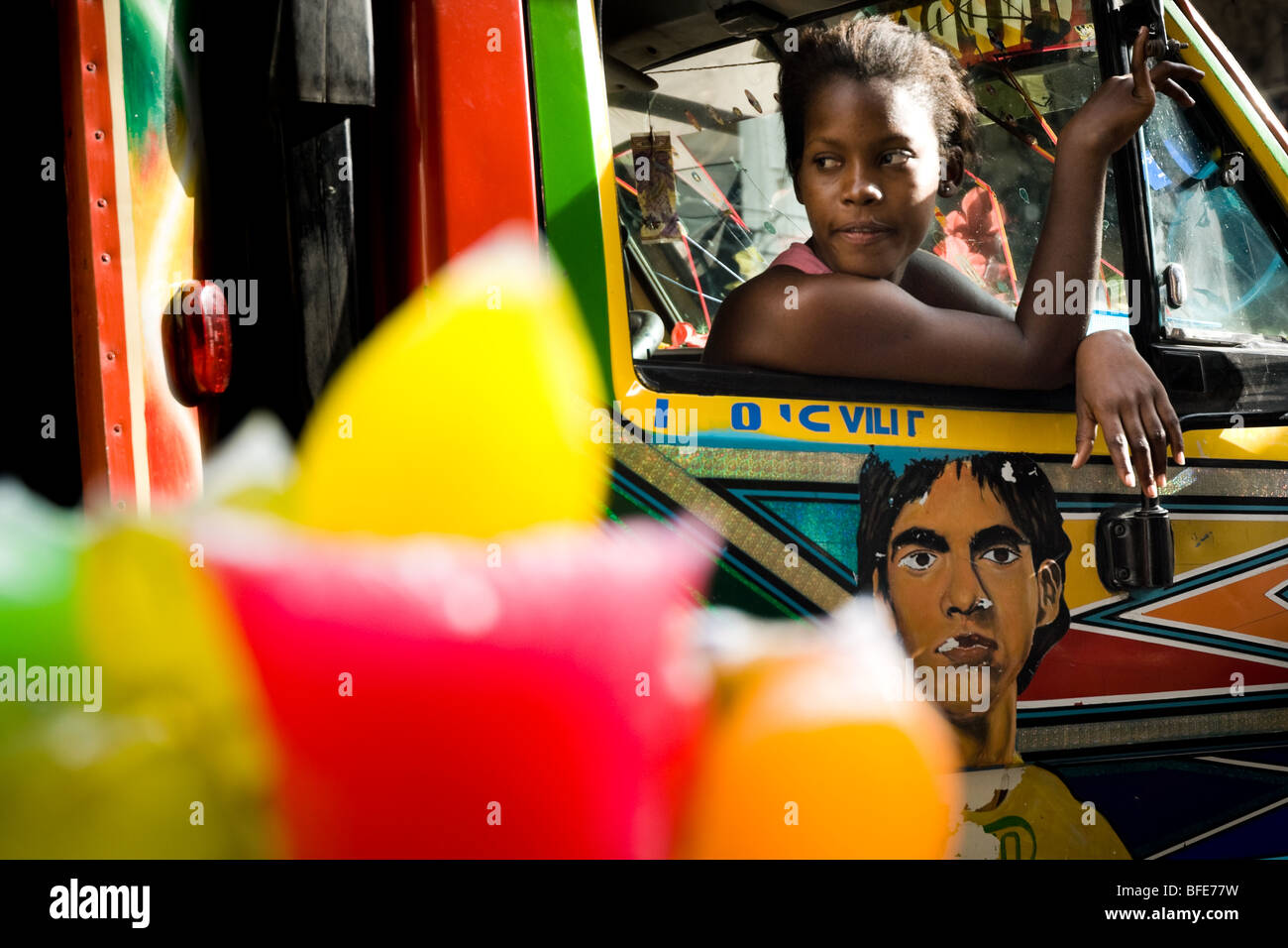 A Haitian girl looking out of the window of the tap-tap bus in the ...
