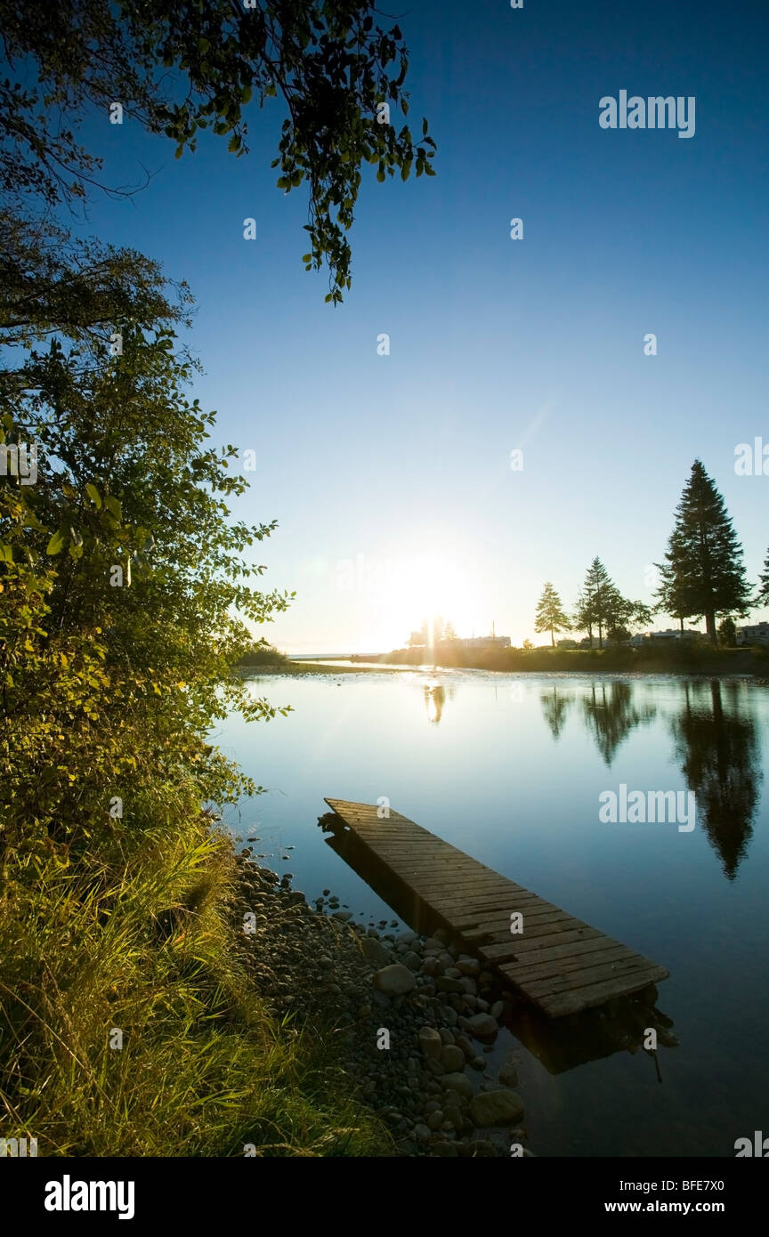 River at sunrise and an aging dock lend an air of tranquility to scene ...