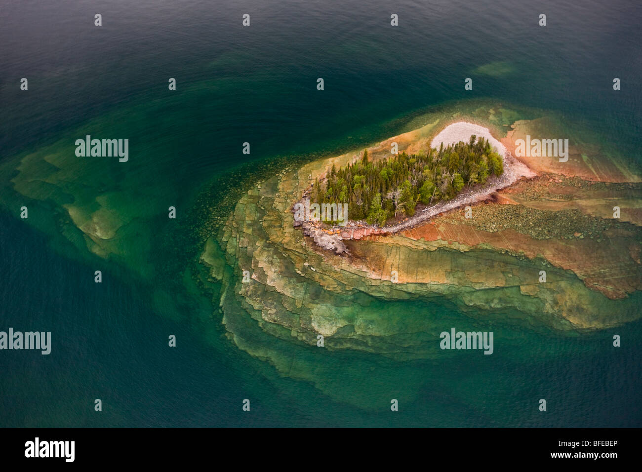 Aerial view of small rocky islands with a clear view through water to ... Aerial view of small rocky islands with a clear view through water to ...