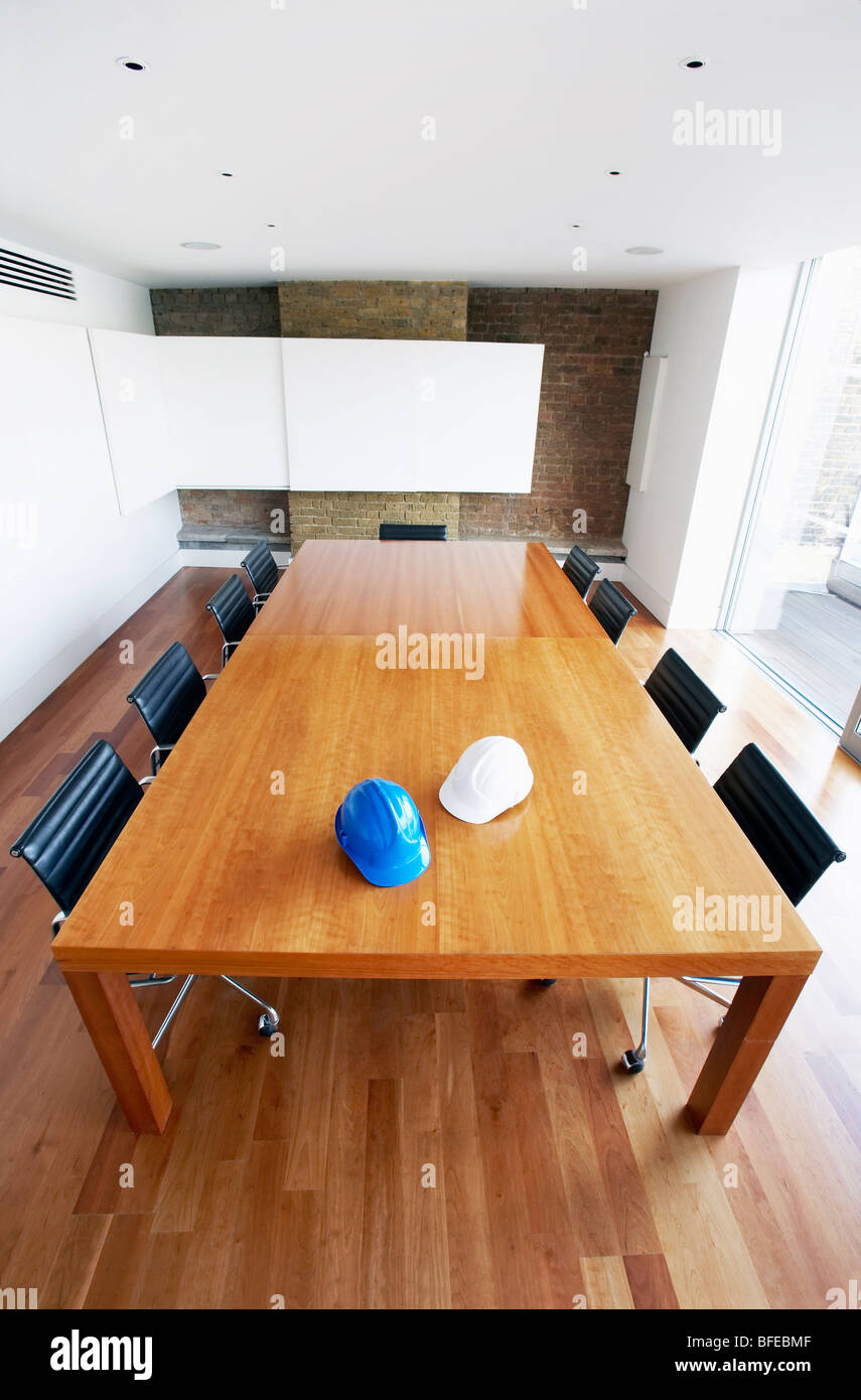 Conference table with hard hats Stock Photo - Alamy