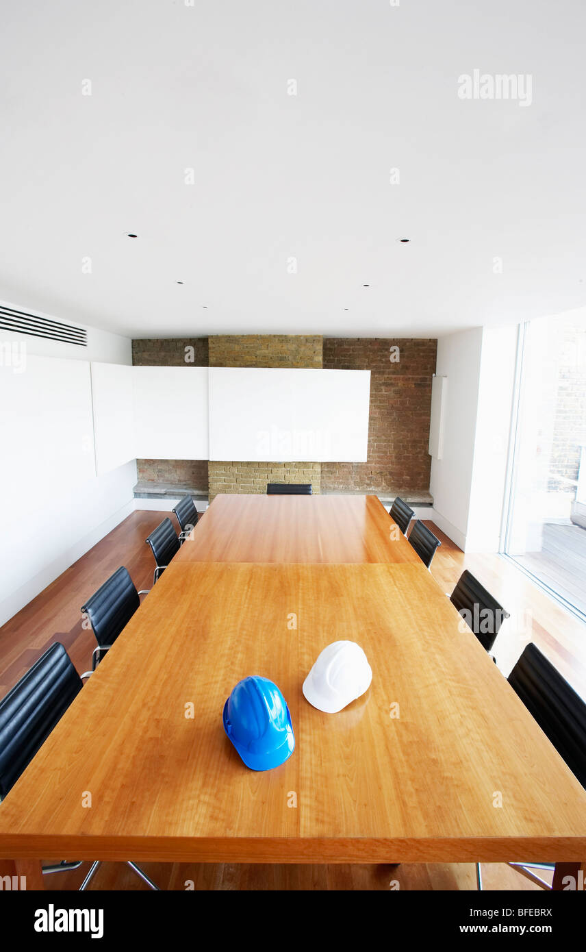 Conference table with hard hats Stock Photo - Alamy