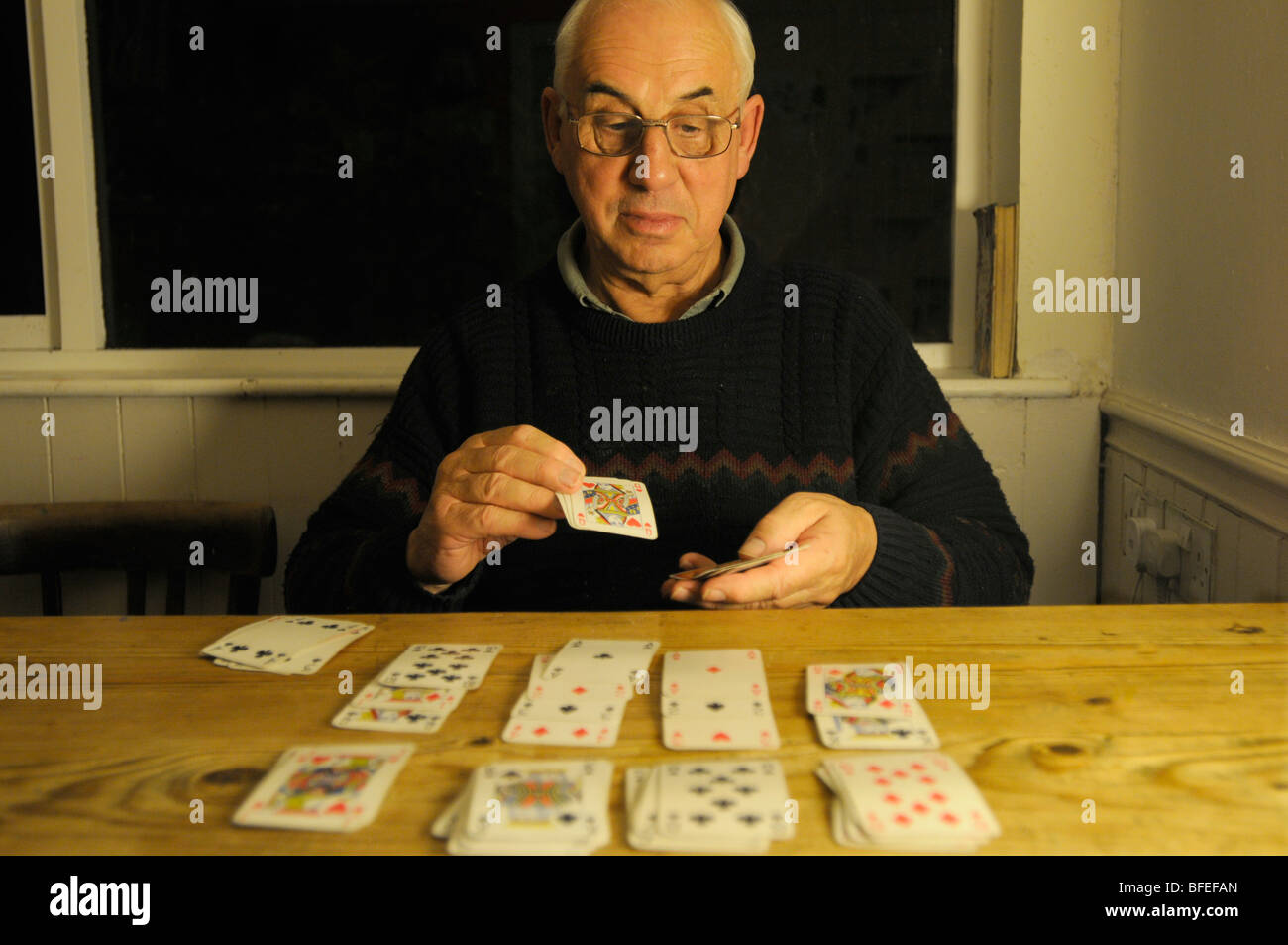 A 65 year old man playing cards Stock Photo - Alamy
