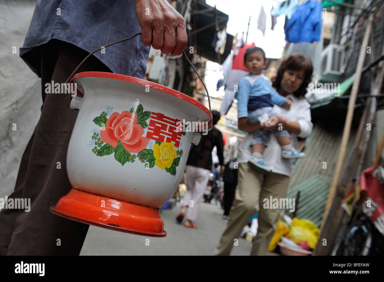 A man with a chamber pot in a Shikumen Lane in Shanghai, China. 19-Oct ...