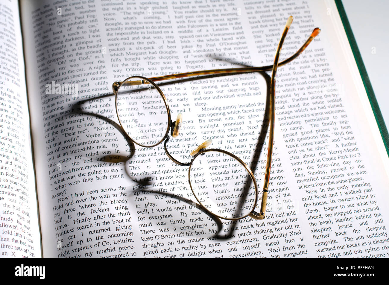 Spectacles sitting on an open book Stock Photo - Alamy