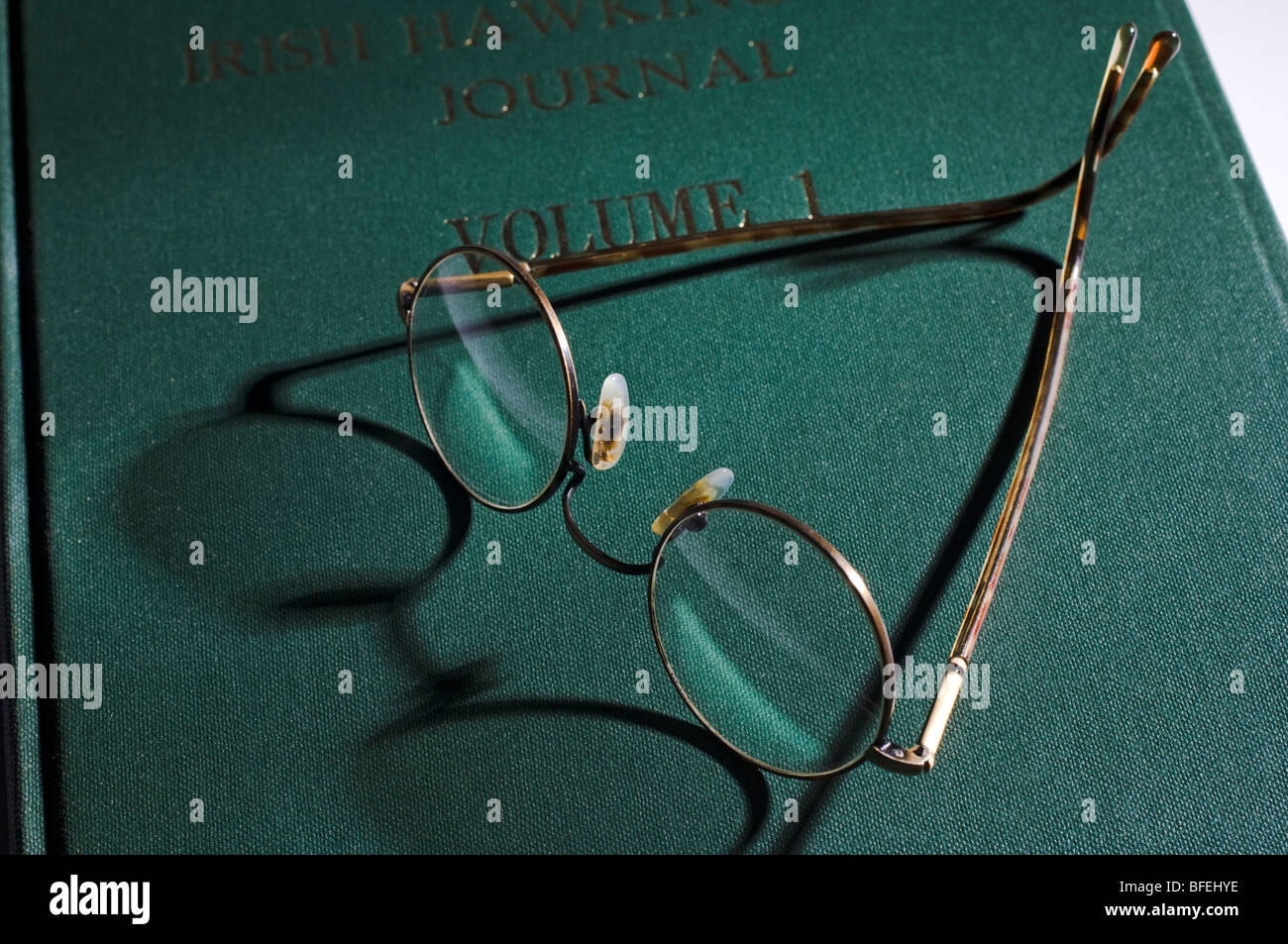 Spectacles sitting on the cover of a book Stock Photo - Alamy