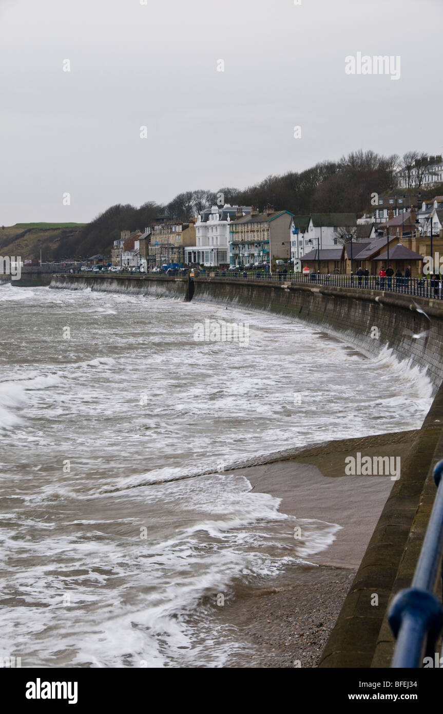 Filey promenade on a windswept day. Showing the waves breaking aginast ...