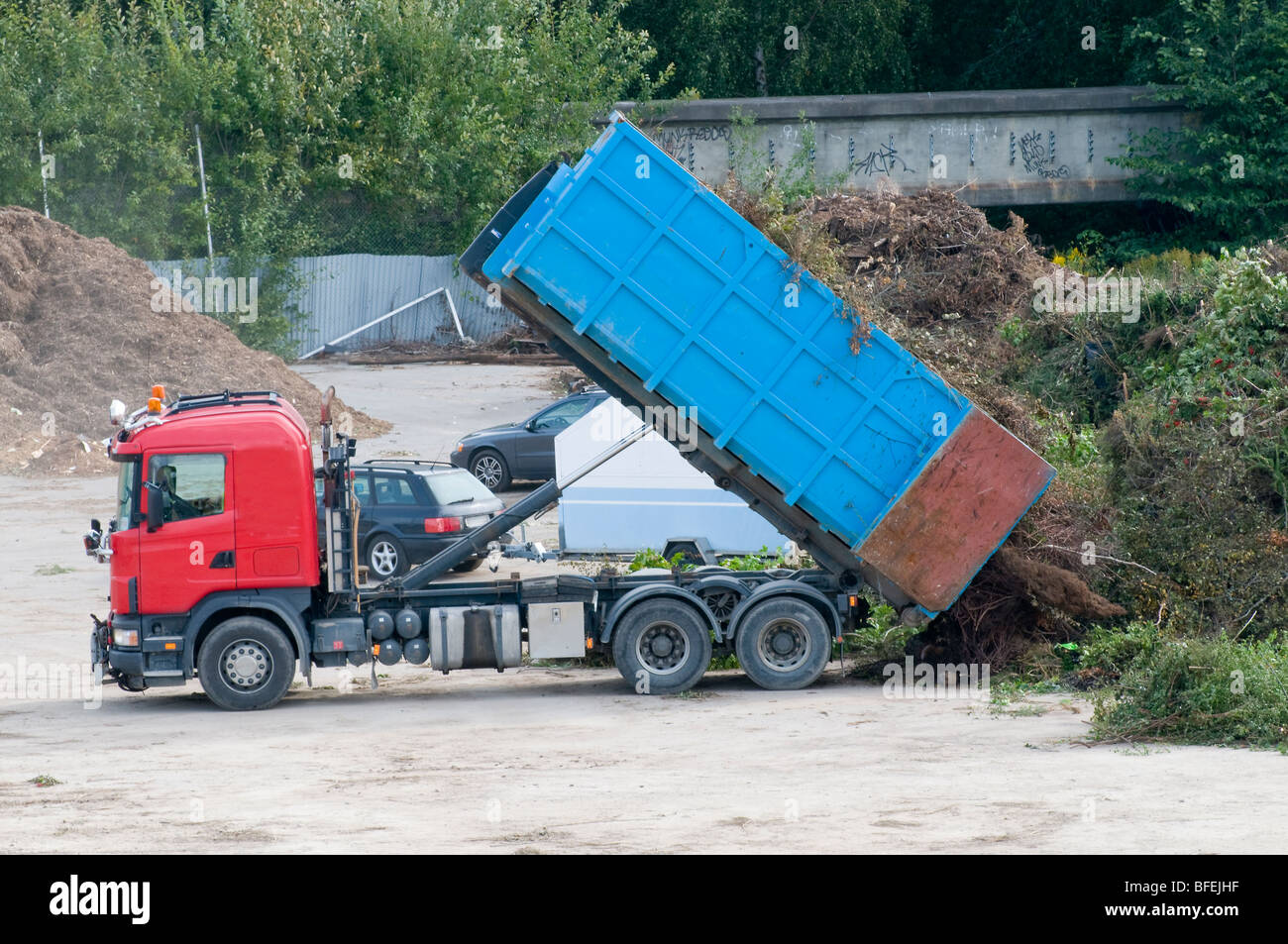 A lorry dumping trees on a dump Stock Photo - Alamy