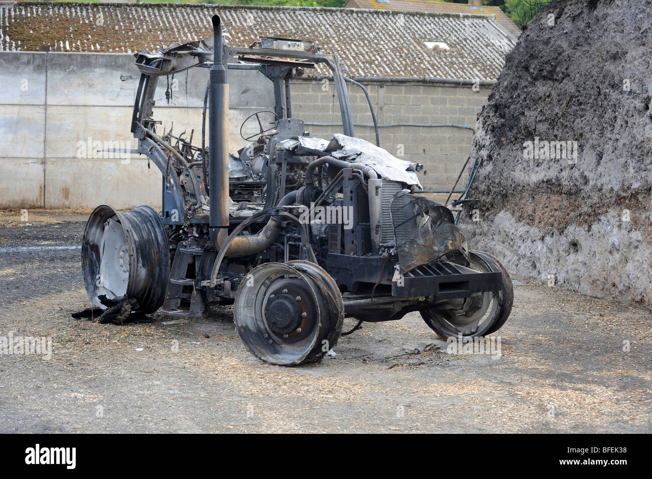 A fire damaged tractor after straw fire in storage area on an East ...