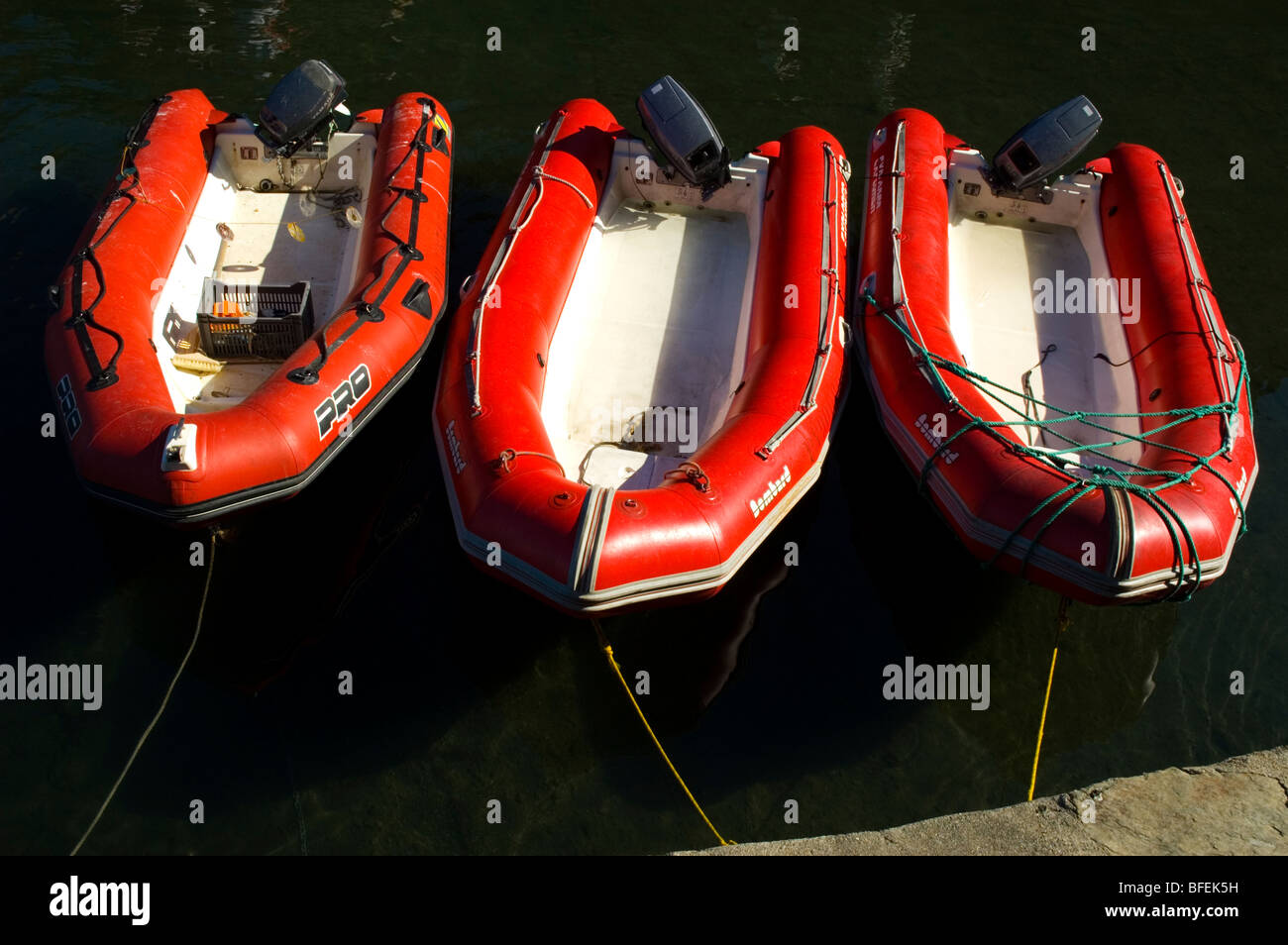 Inflatable boats tied up to a jetty in Collioure, southern France Stock ...