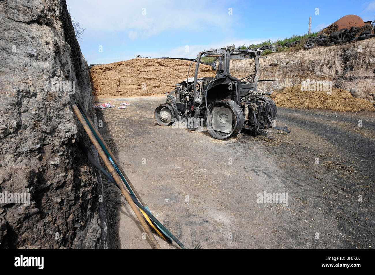 A fire damaged tractor after straw fire in storage area on an East ...