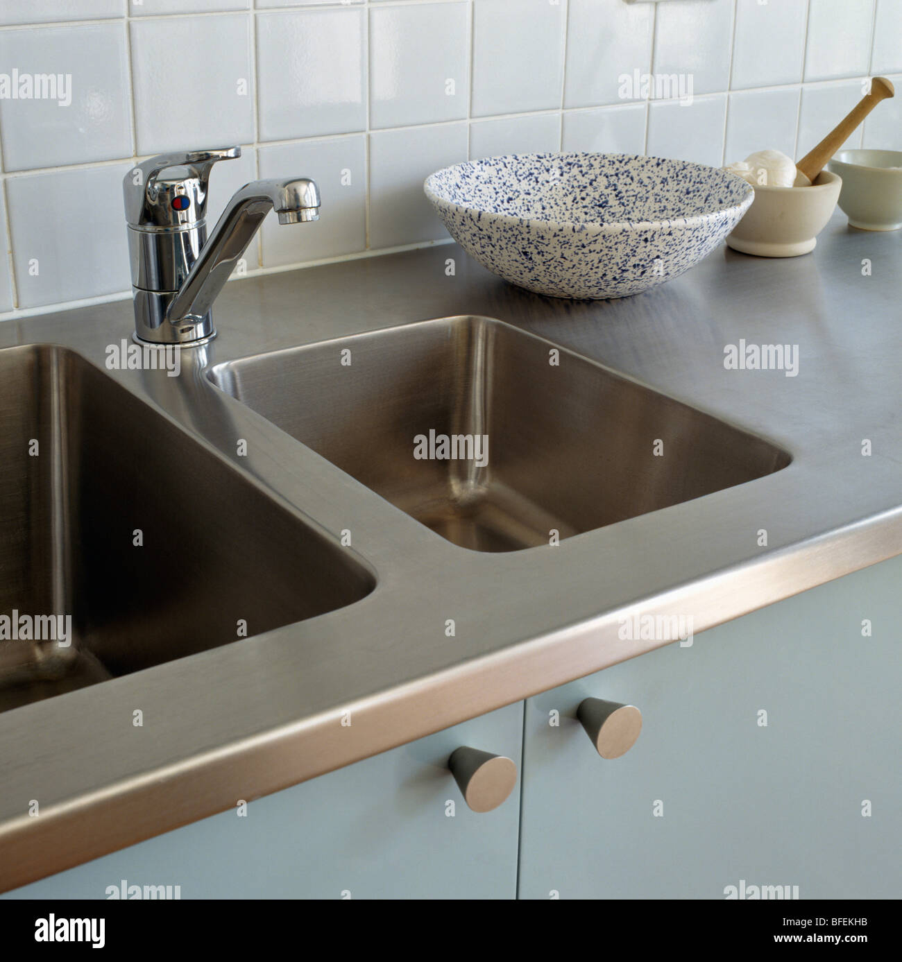 Close-up of double stainless steel sinks with mixer tap in stainless ...
