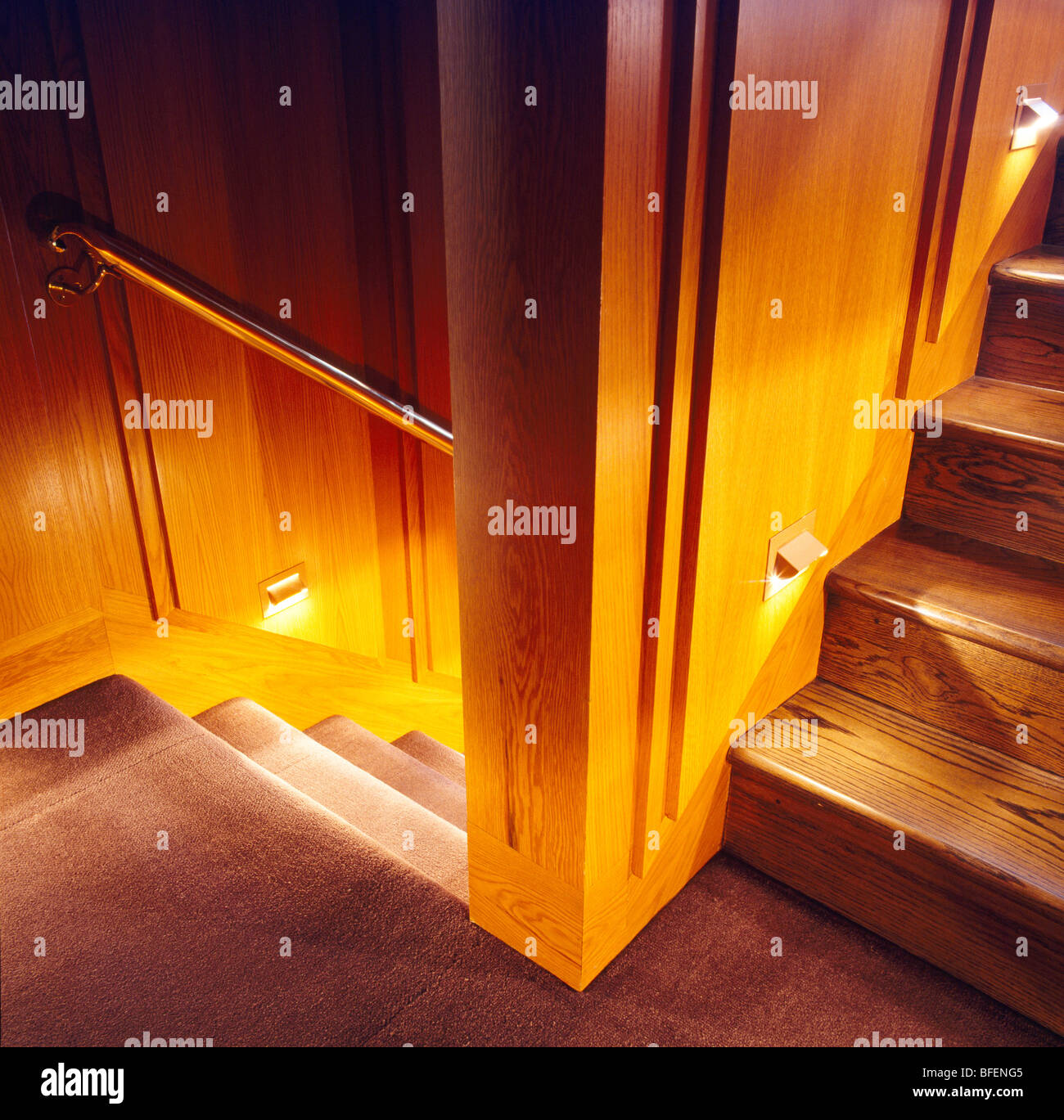 Lighting above stairs and small wood-panelled landing Stock Photo - Alamy