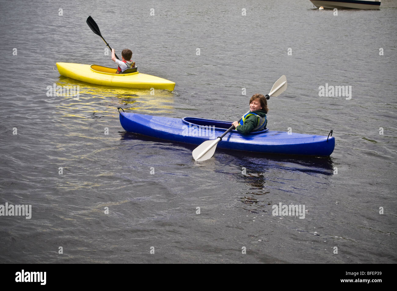 Two colorful kayak's paddle on lake Stock Photo - Alamy