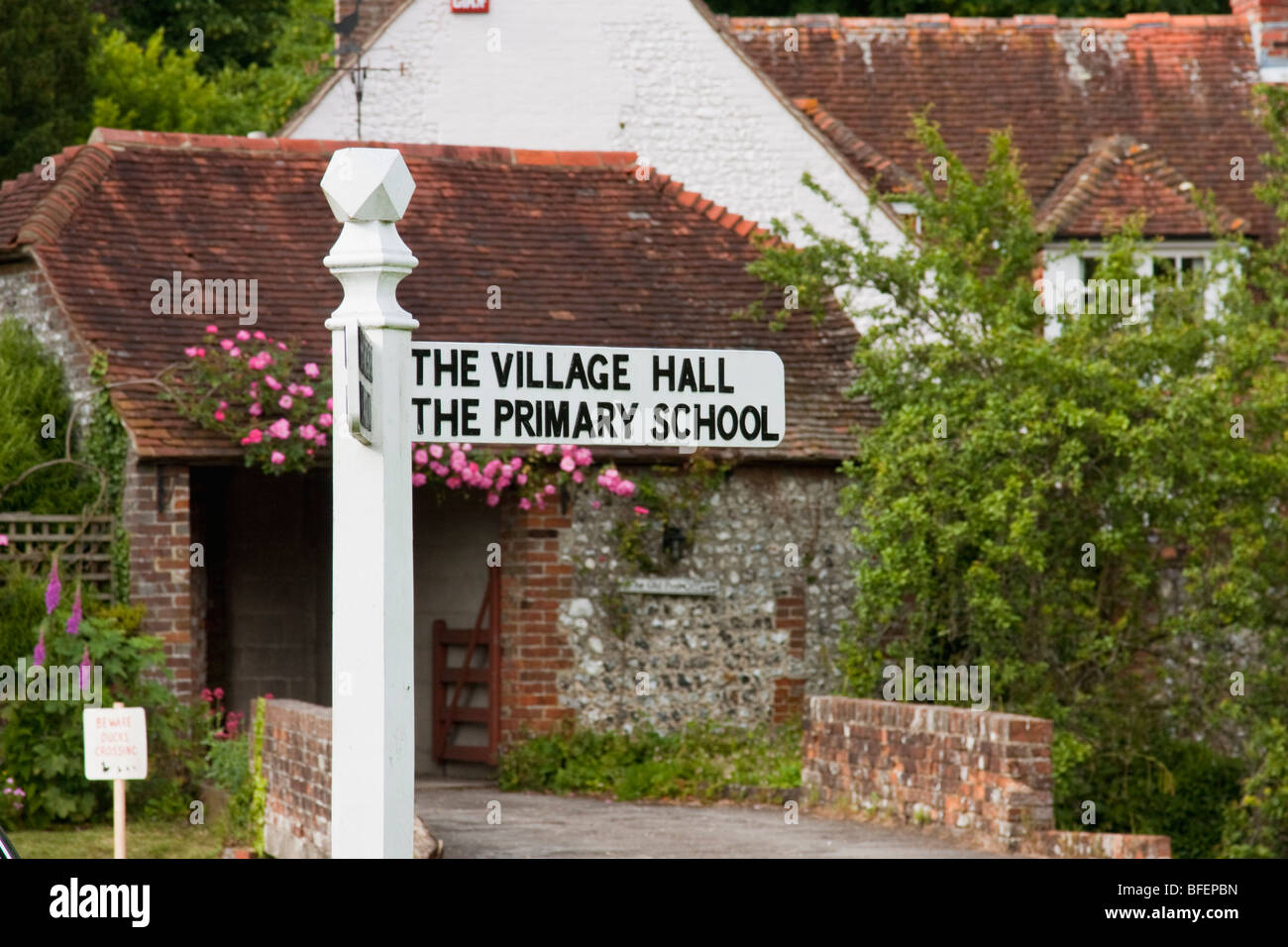 Sign showing the village hall and the primary school in a small village ...