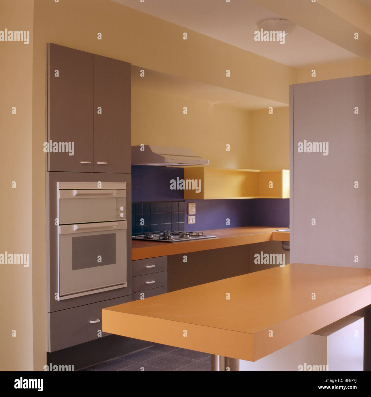 Wood worktop in modern kitchen with eye-level white oven Stock Photo ...