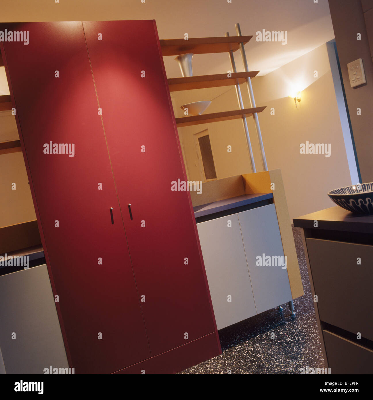 Fitted red storage cupboard in modern kitchen Stock Photo - Alamy