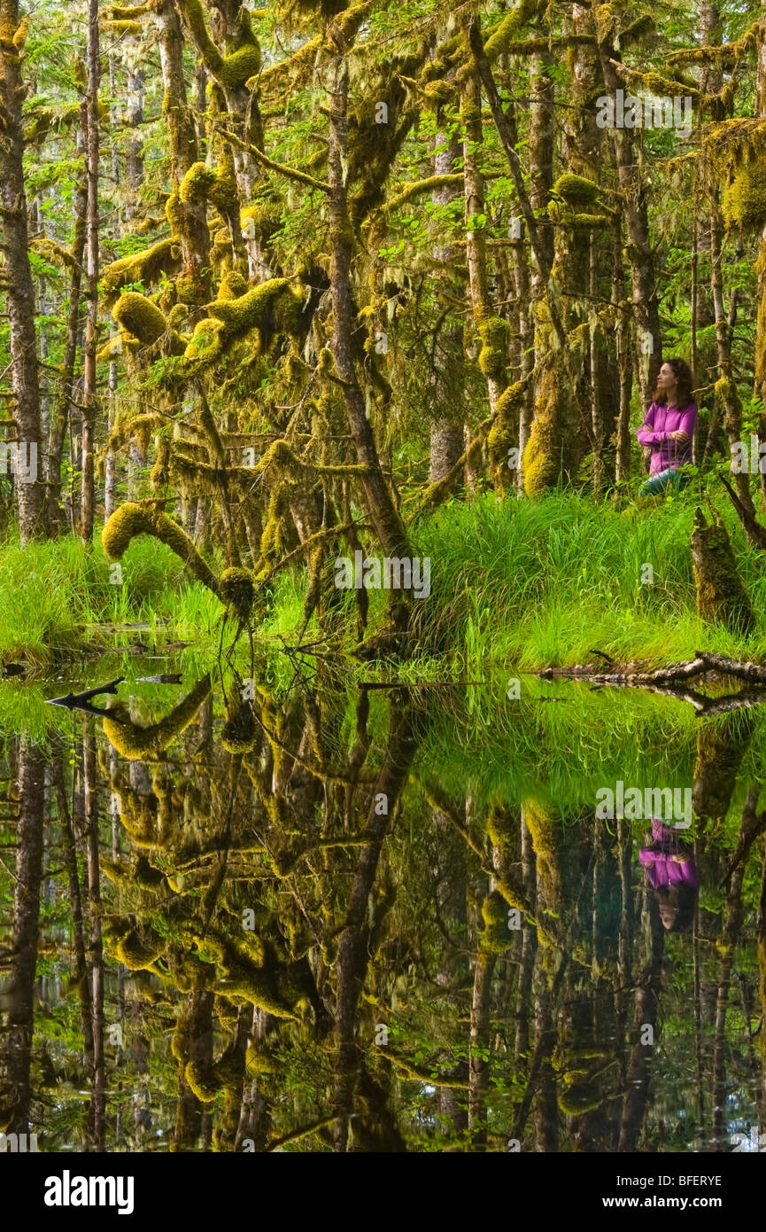 Woman in mossy swamp, Naikoon Provincial Park, Queen Charlotte Islands ...