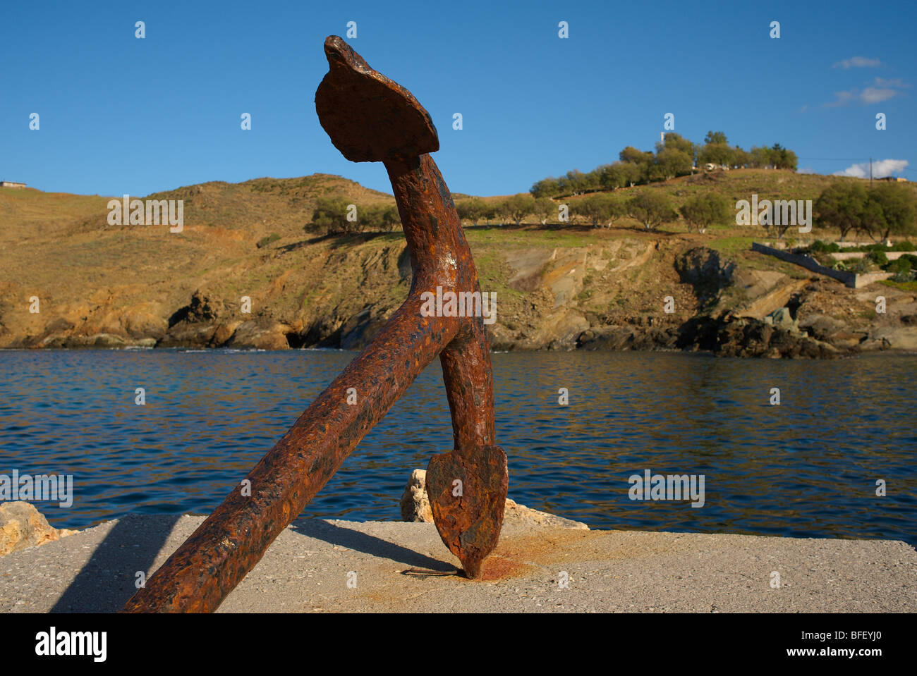 Huge old anchor lying on the harbour wall at Panormo Crete Greece Stock ...