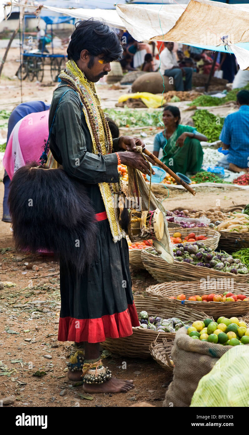 Religious Indian musical beggar man, dressed in costume with flute ...