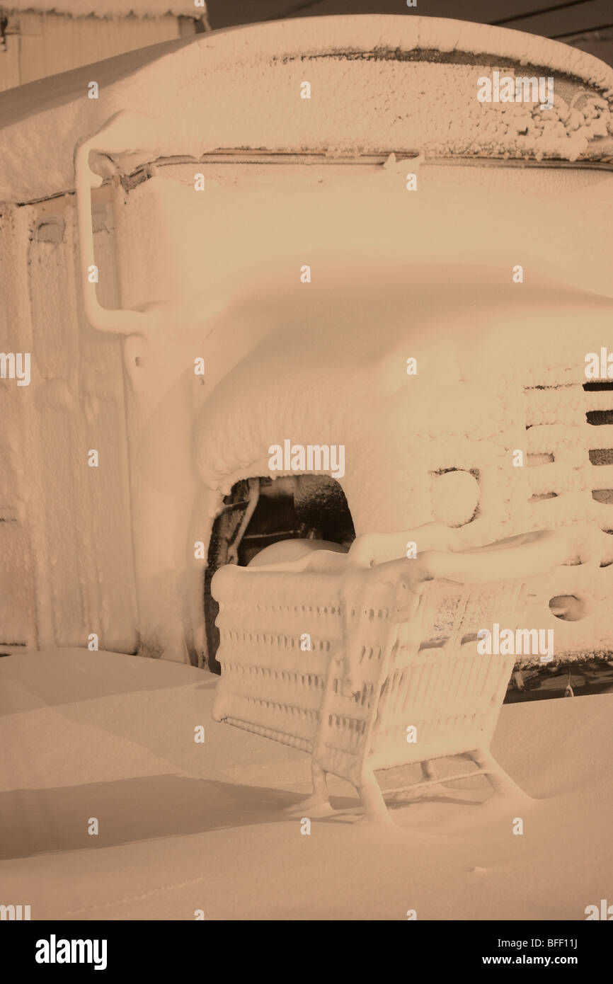 Snow covered school bus and shopping cart after a blizzard, Churchill ...