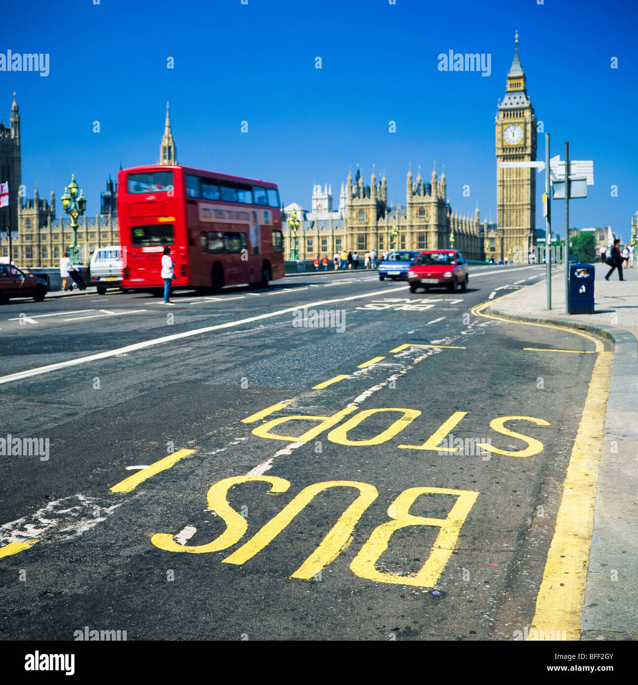 Bus stop sign and red double decker bus on Westminster bridge and ...