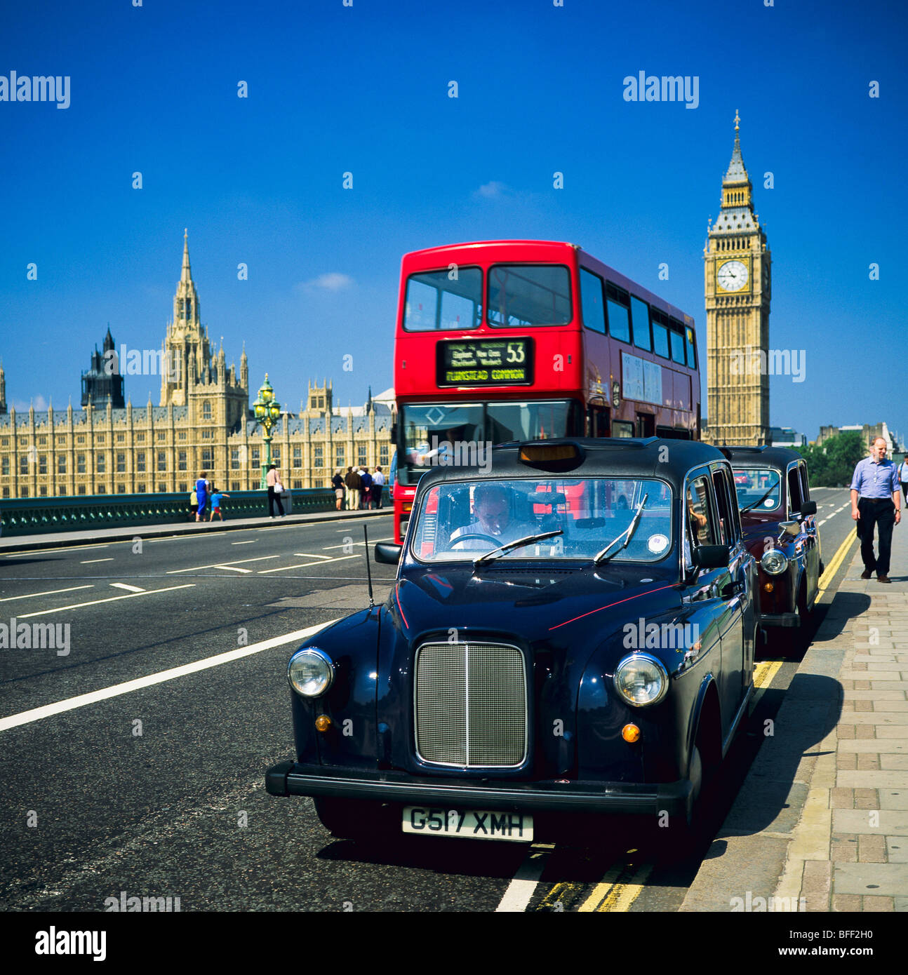 Black taxis and red double decker bus on Westminster bridge and ...