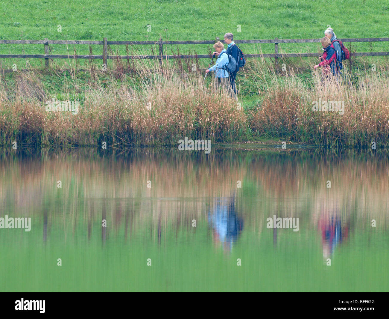 Four old women walking around a lake Stock Photo - Alamy