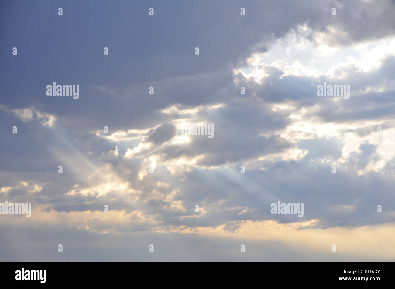 Sun rays piercing clouds Stock Photo - Alamy