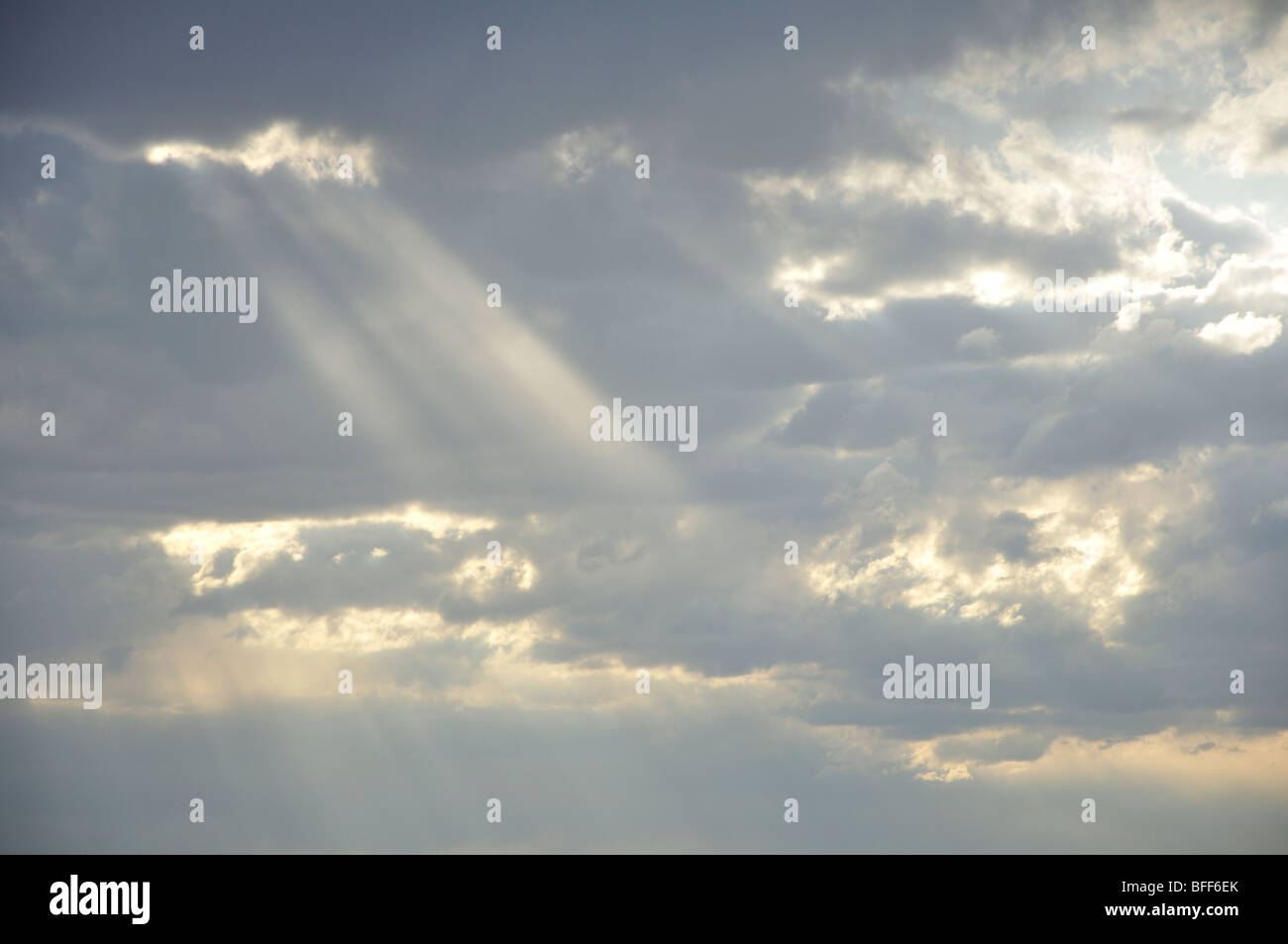 Sun rays piercing clouds Stock Photo - Alamy