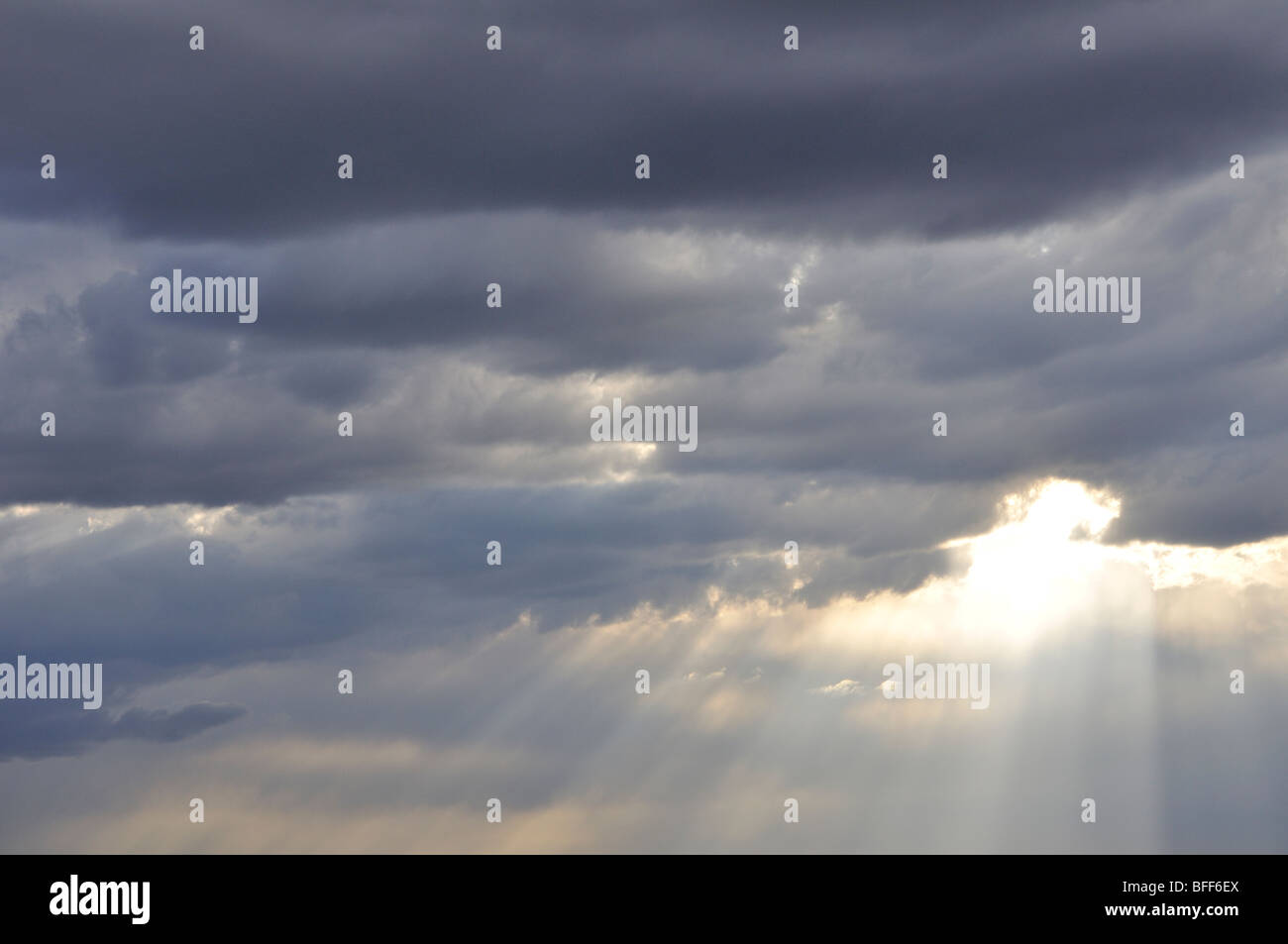 Sun rays piercing clouds Stock Photo - Alamy