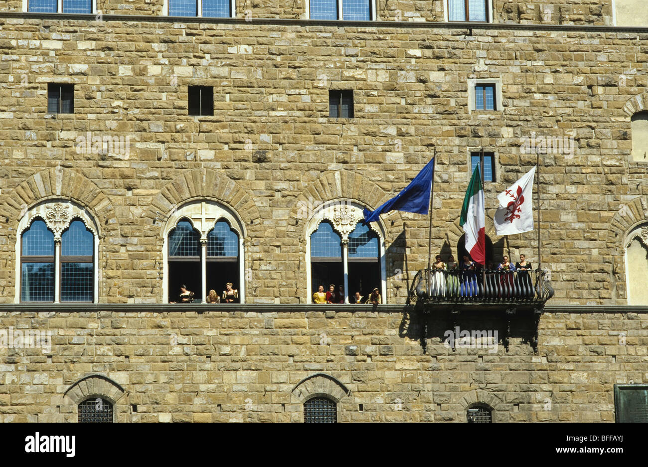 Women in renaissance costume in the window and on the balcony of the ...