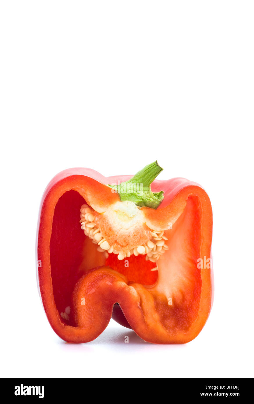Single Red pepper or Capsicum, Cut in Half, on a White Background Stock ...